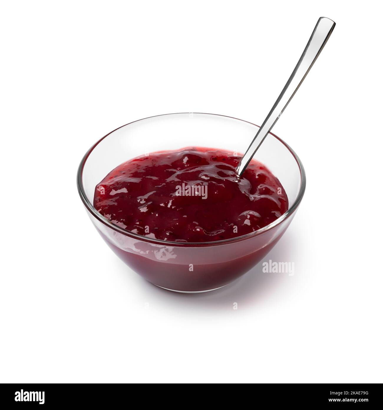 Glass bowl with red fruit jam close up isolated on white background ...