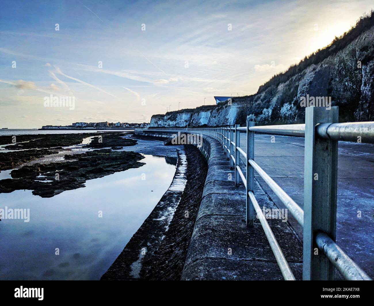 The coastline seawall view with the sunrise sky behind the cliffs Stock ...