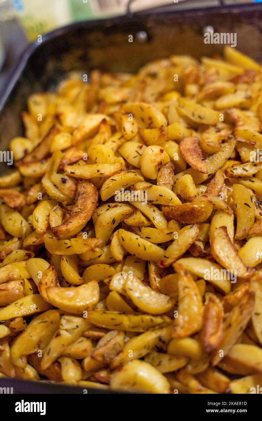 Delicious freshly oven baked crispy seasoned potatoes Stock Photo - Alamy