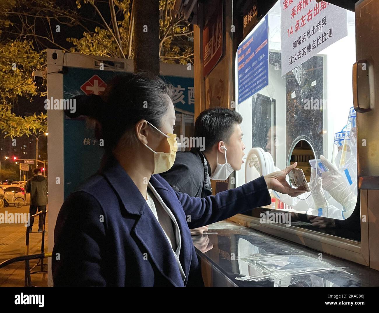 People take a swab sample for COVID-19 nucleic acid testing in Beijing ...