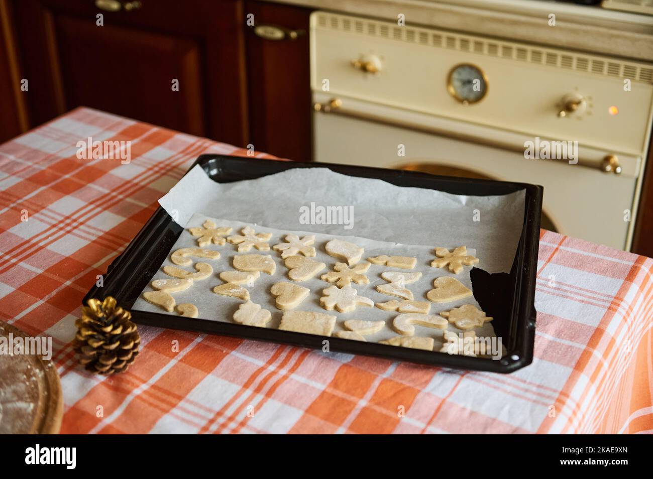 Carved gingerbread cookies in the shape of a heart, candle, candy cane ...