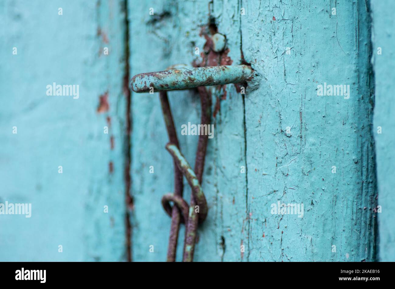 Old rusted padlock and metal fragments on old colorful wooden doors ...