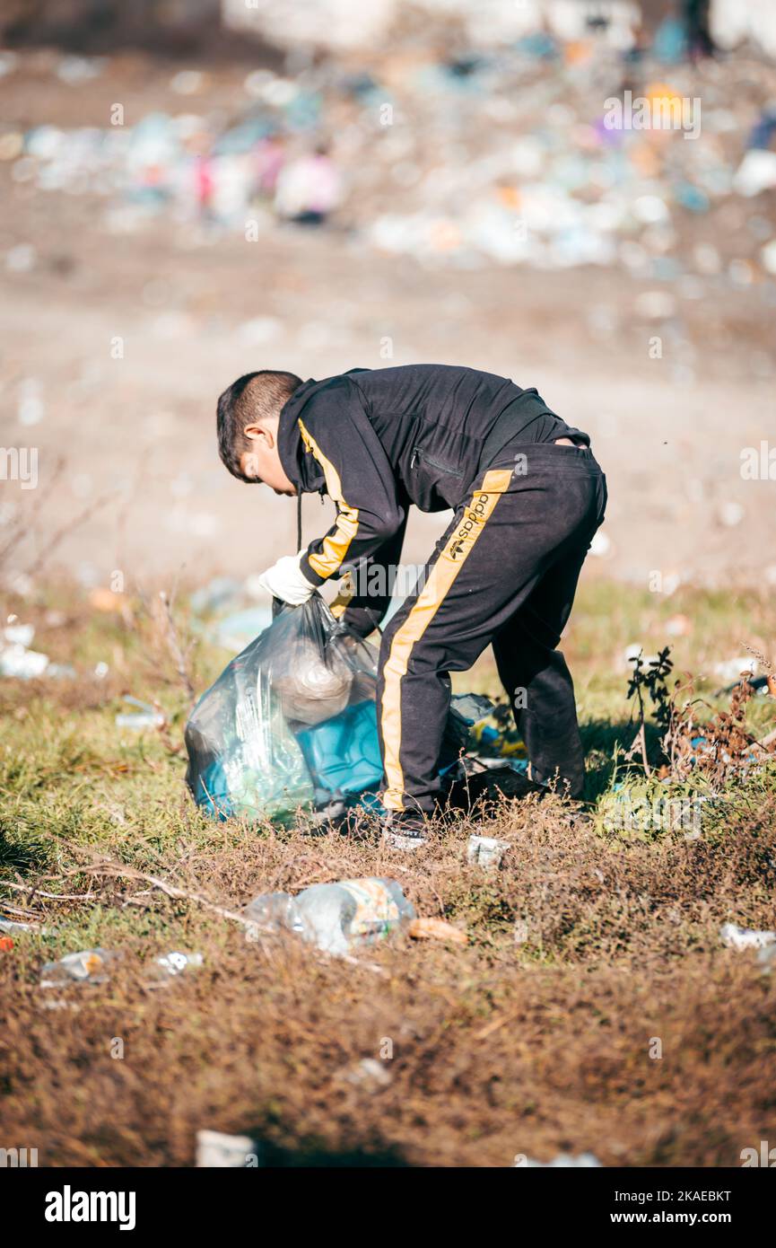 A poor gypsy boy collecting trash in exchange of food Stock Photo - Alamy