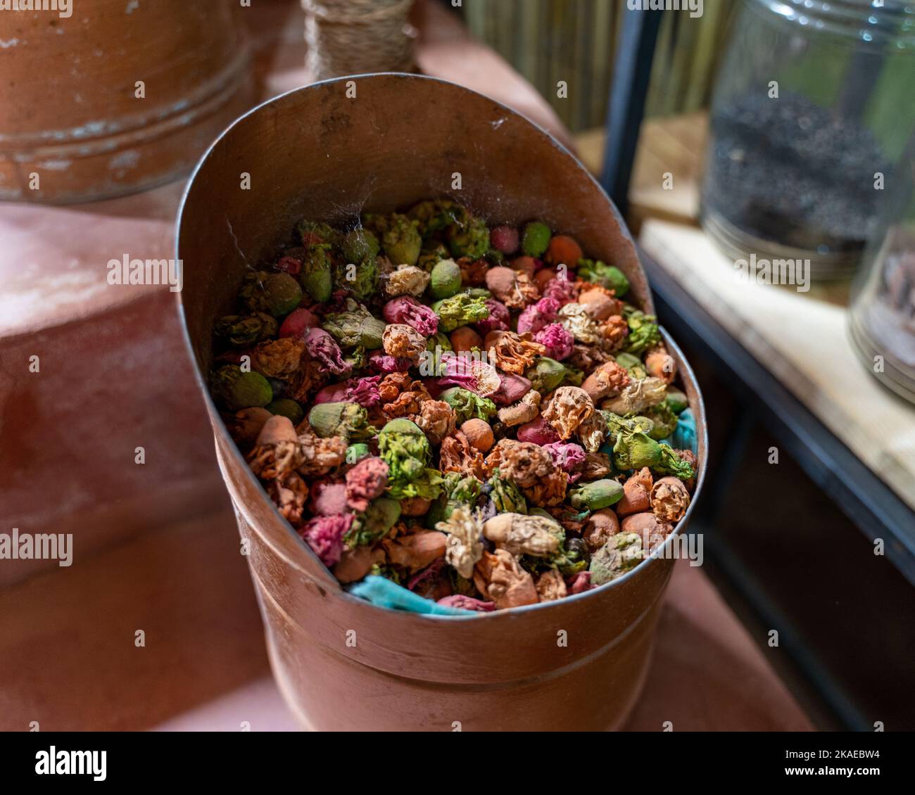 A bunch of colorful dried flower buds and plants in a big bucket used ...