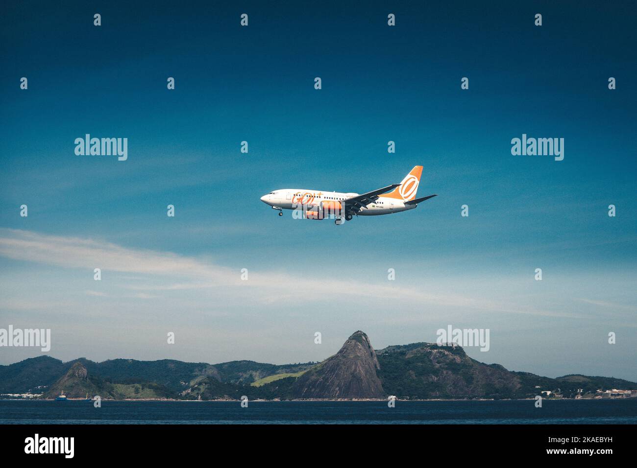 An airplane preparing for a landing over the Atlantic Ocean in Rio with ...