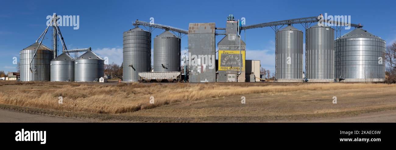 Metal grain bins and an old grain elevator with a faded Buy Dakota Maid ...