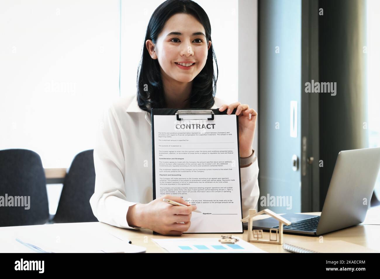 estate agent gives pen and documents agreement with customer to sign ...