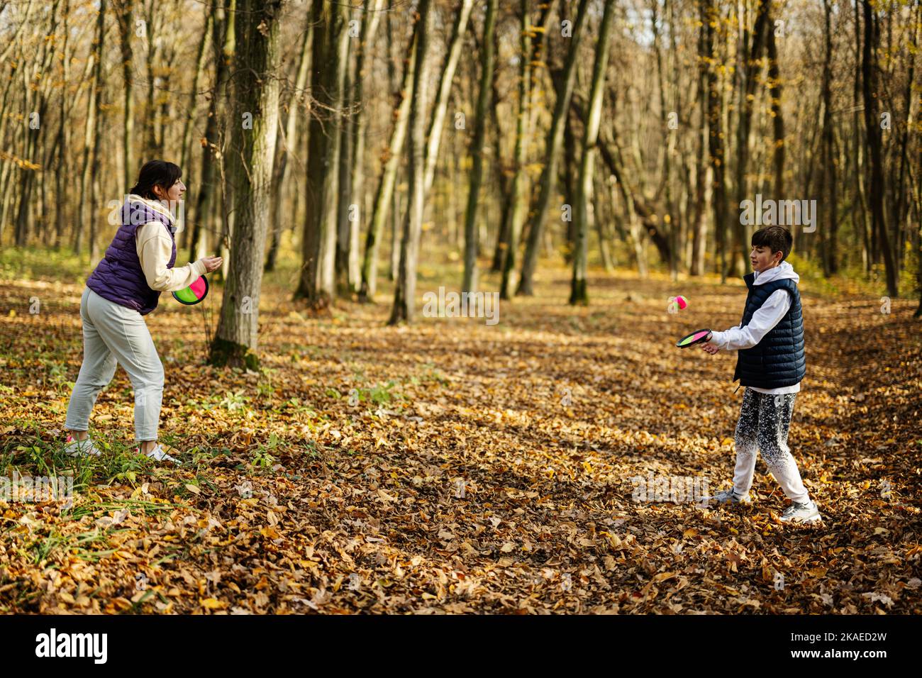 Mother with son play in autumn forest catch and toss ball game Stock ...