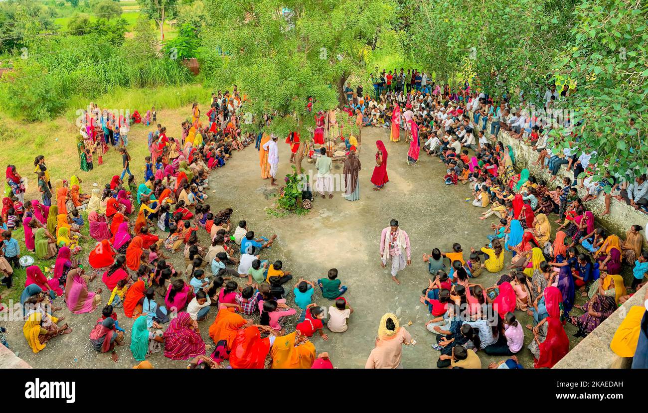 A view of people dancing in a garden with green trees Stock Photo - Alamy