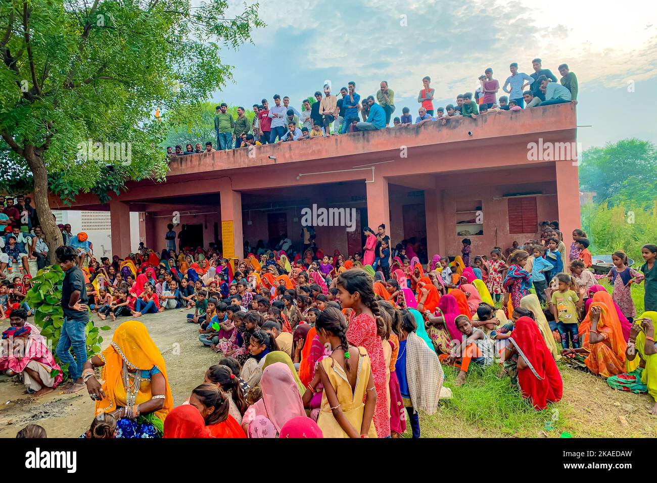 A view of people dancing in a garden with green trees Stock Photo - Alamy