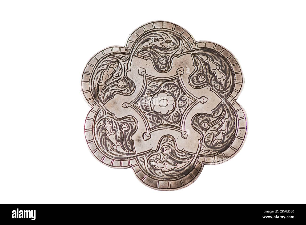 An artistic flower shape coin with beautiful engravings on a white ...
