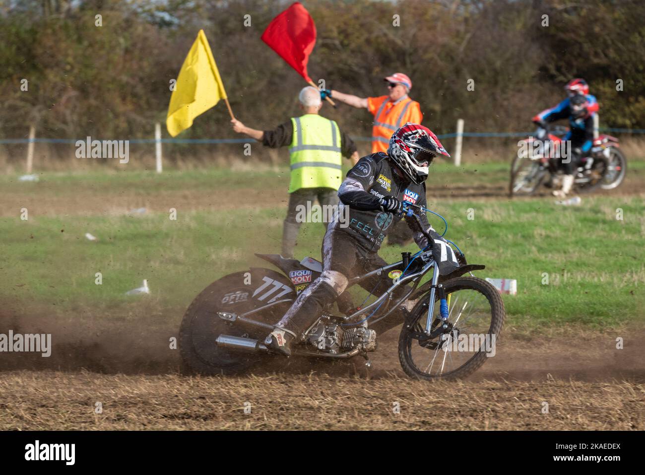 Red flag waving to stop racing in grasstrack motorcycle race. Donut ...