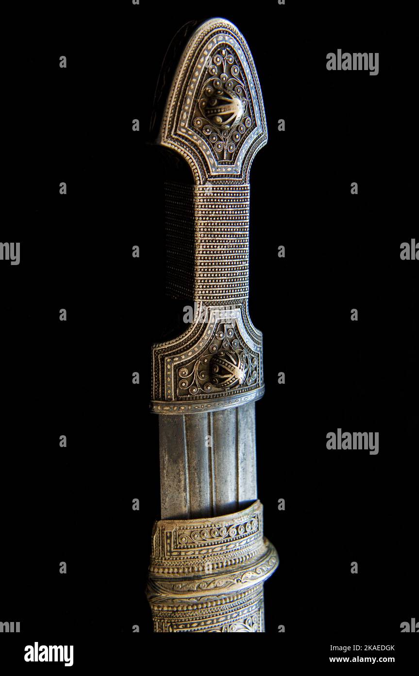 The handle of an antique dagger with artistic chasing and engraving on ...