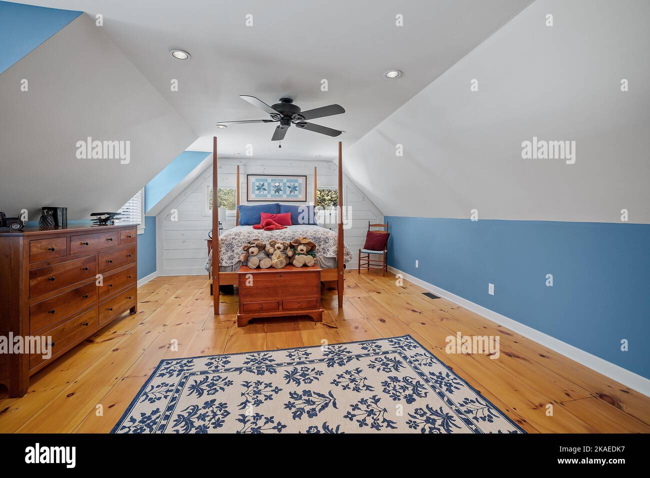 A comfortably furnished vintage bedroom with a high pole bed with ...