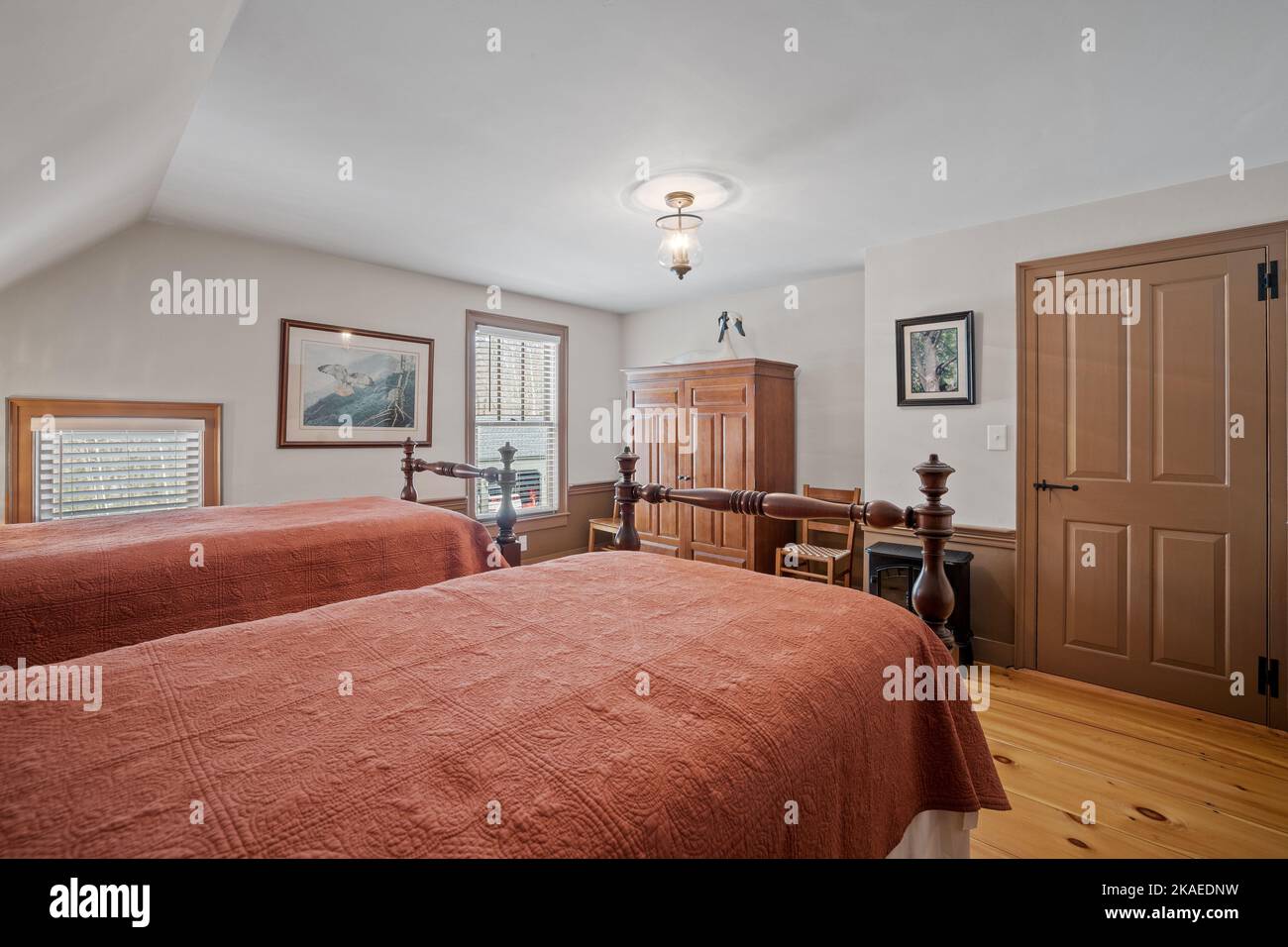 A vintage decoration of a comfortable bedroom with two old style beds ...