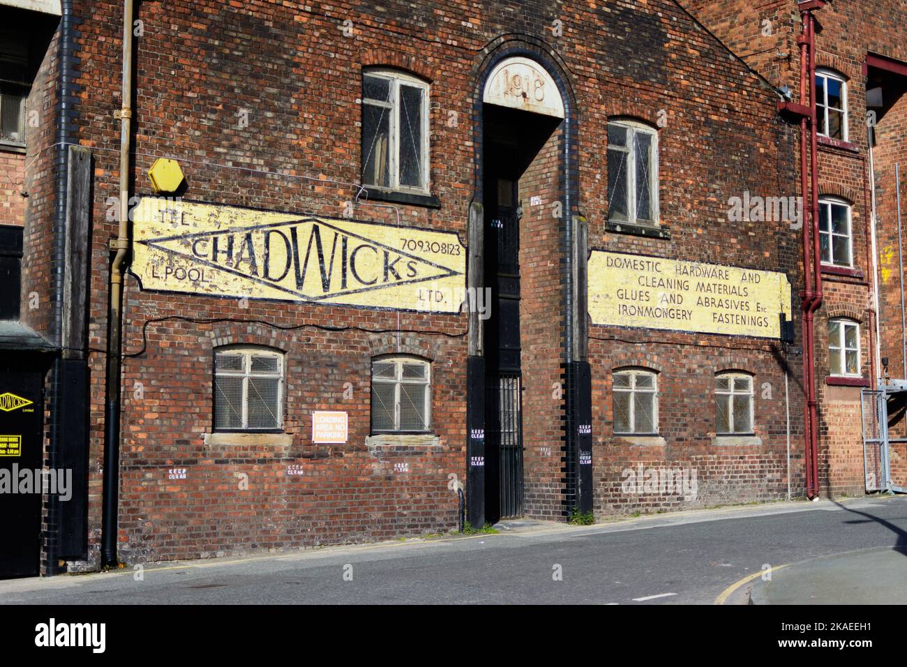 An old brick house with "Chadwicks" inscription in an industrial area ...