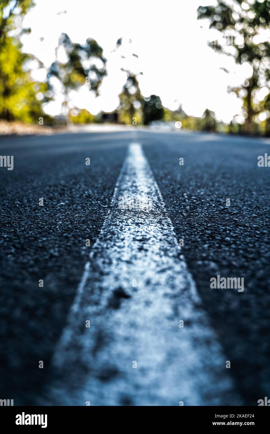 An old white lane on the middle of an asphalt road Stock Photo - Alamy