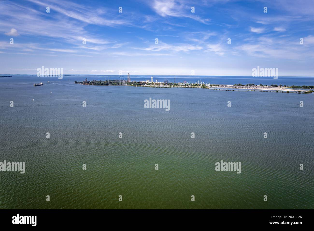 An aerial drone view of the Cedar Point amusement park under a blue ...