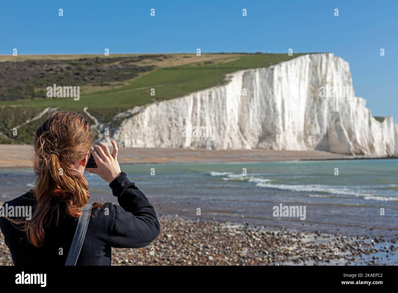 Cuckmere Haven, boy taking pictures of white cliffs The Seven Sisters ...