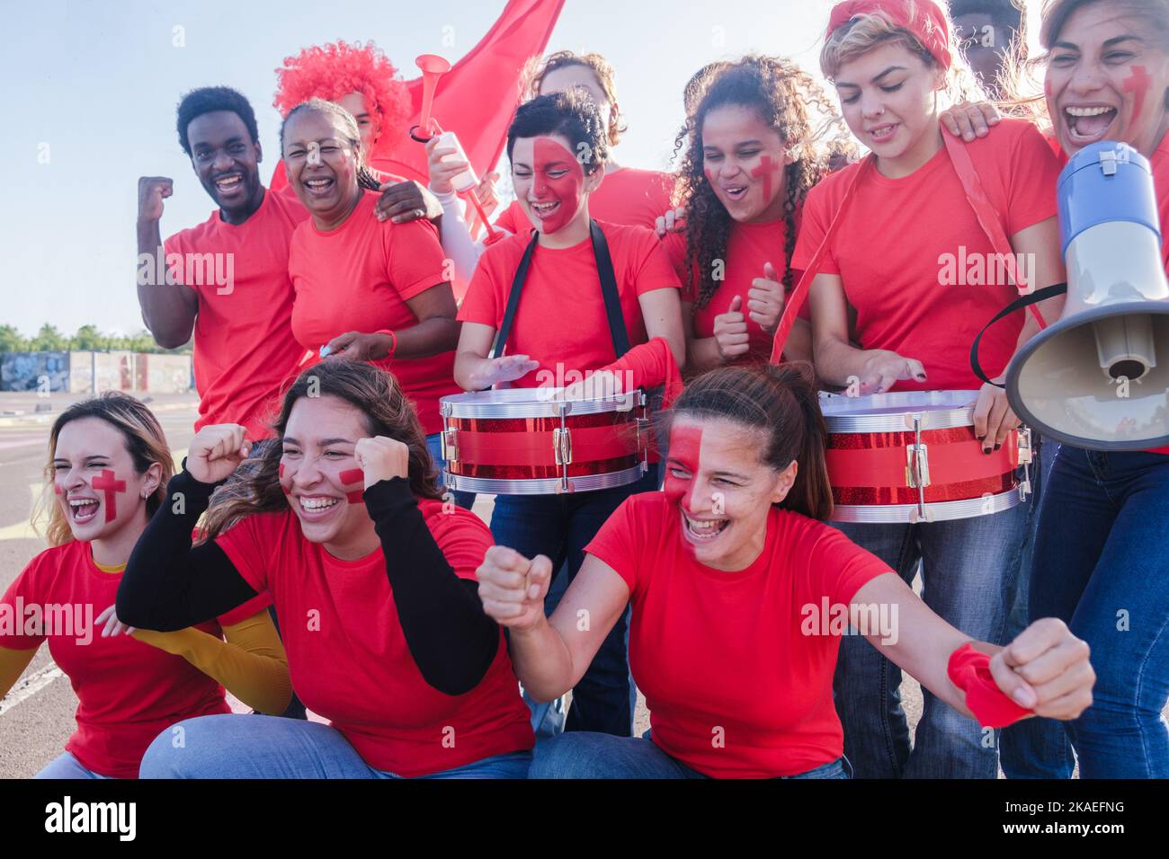 Group of fans of a team cheering and singing together in support of ...