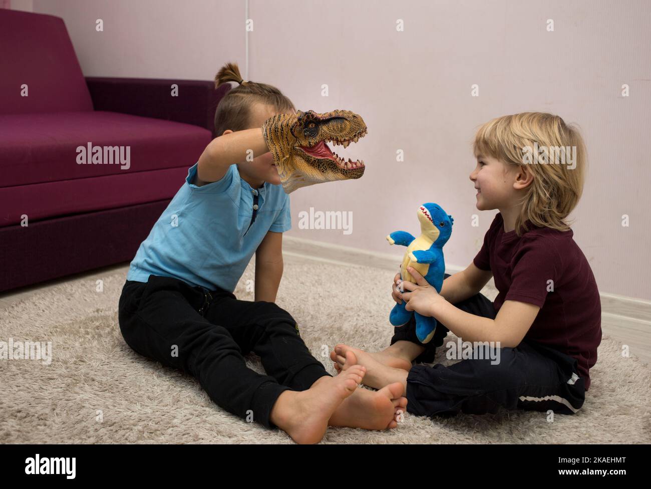 preschool boys play role playing games with dinosaur toys sitting on ...