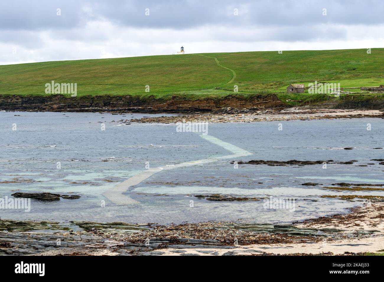 High tide in concrete pathway to the island Brough of Birsay, The ...
