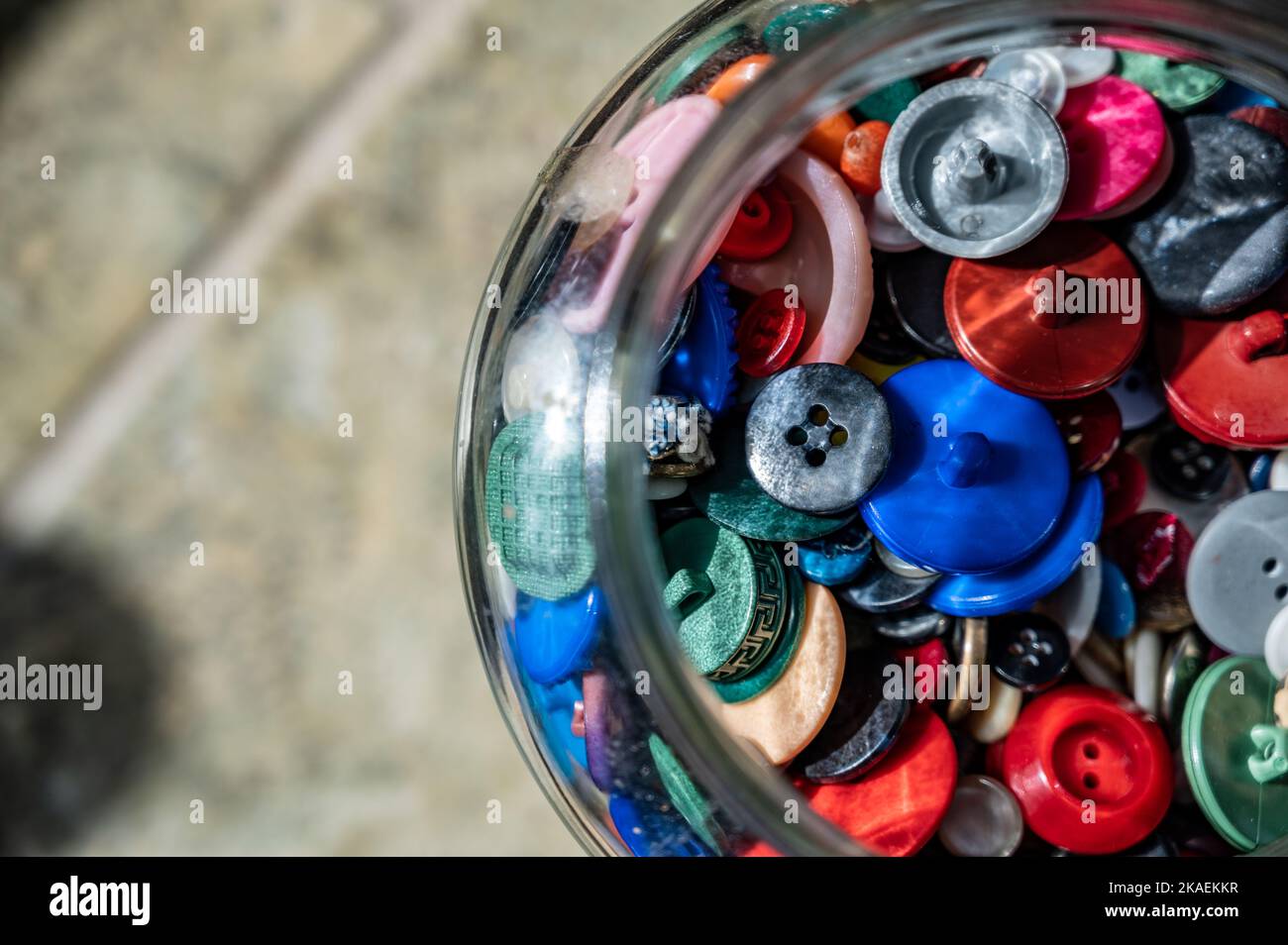 assortment random colored loose buttons in a glass jar Stock Photo - Alamy