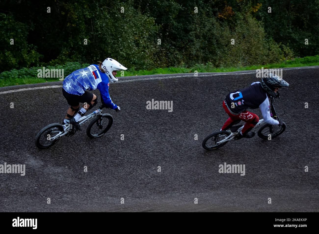 Two BMX race riders shown going round a berm Stock Photo - Alamy