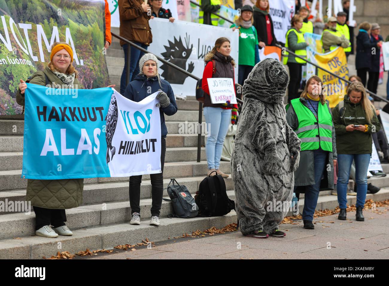 The defenders of the forest hold banners on the steps of the Parliament ...