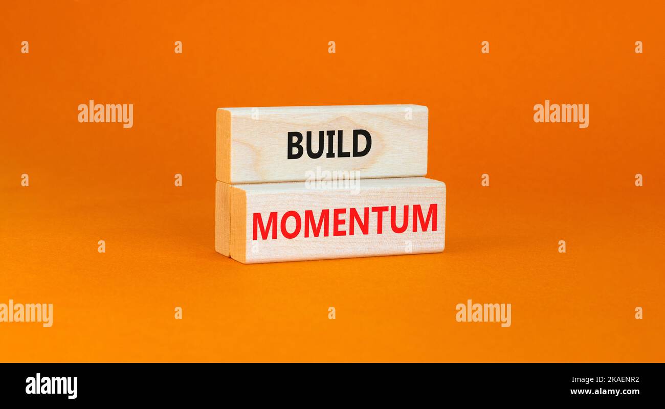 Build momentum symbol. Concept words Build momentum on wooden blocks ...
