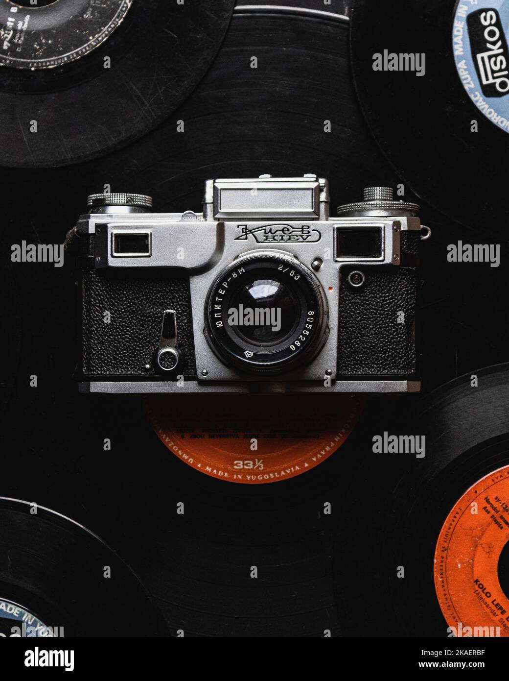 A vertical closeup of a retro camera on phonograph records Stock Photo ...
