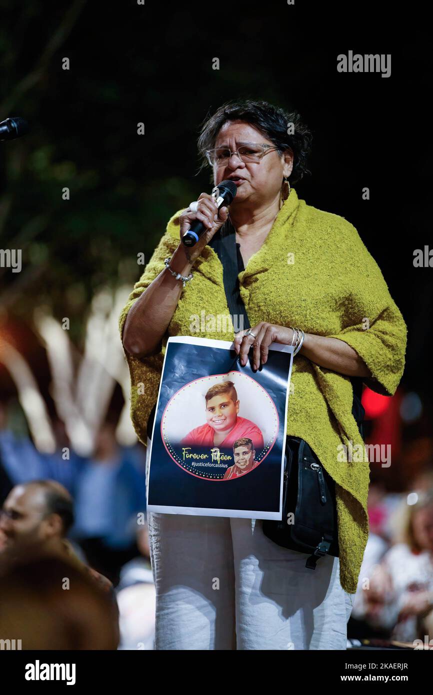 A protester with Cassius Turvey portrait speaks to the crowd during a ...