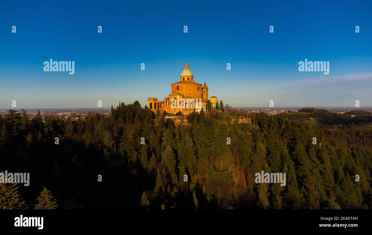 An aerial view of San luca chuch surrounded by dense trees in Italy ...