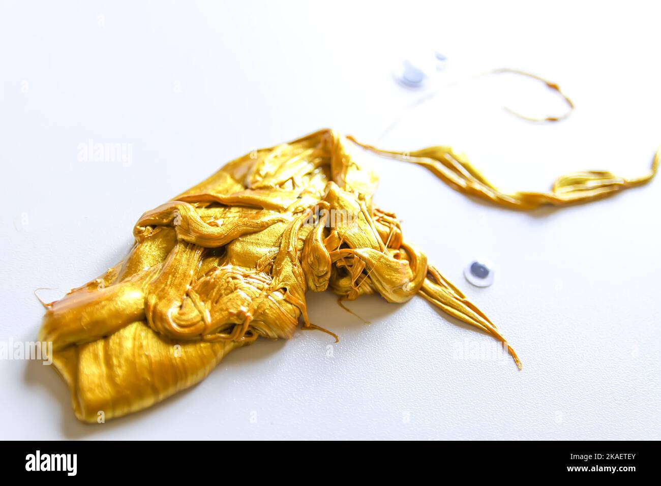 Golden plasticine soft stretchable texture. Anti-stress toy for kids ...