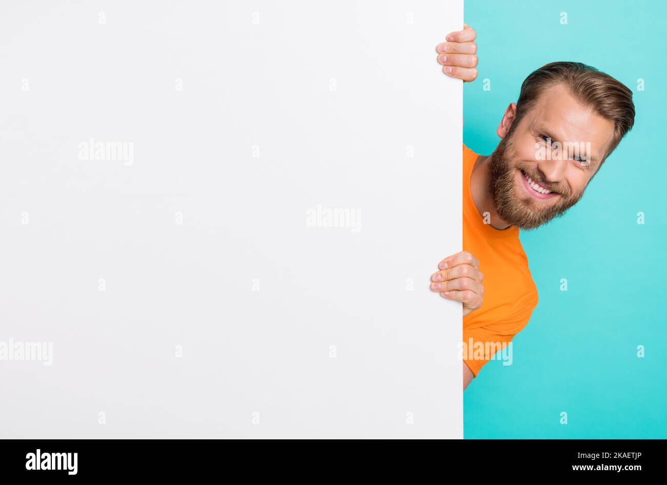 Photo of funny good mood man with blond hairstyle dressed orange t ...