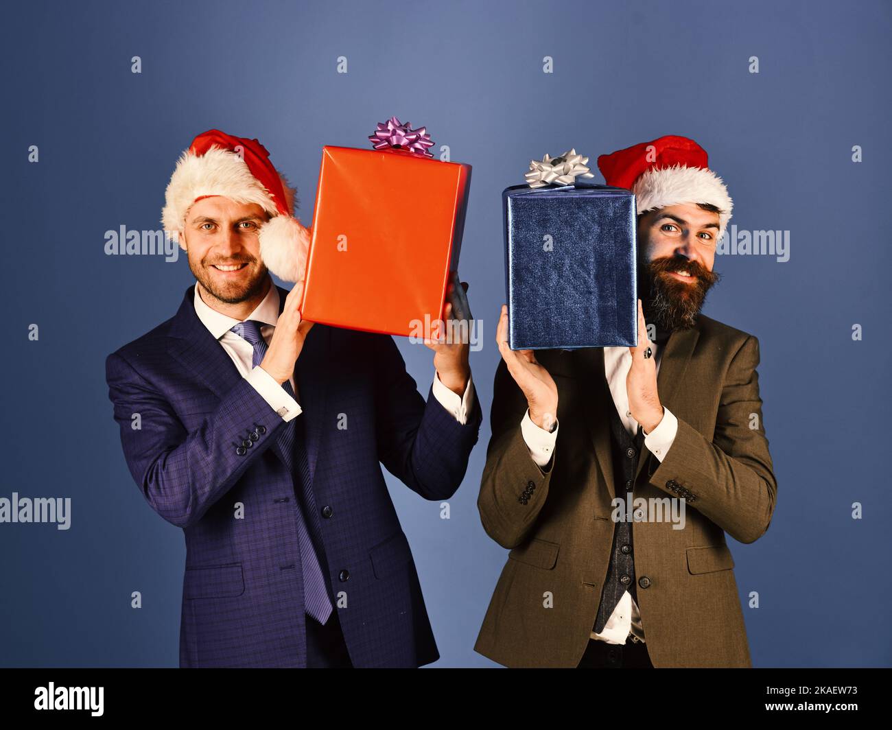 Businessmen with cheerful faces hold red and blue present boxes Stock ...
