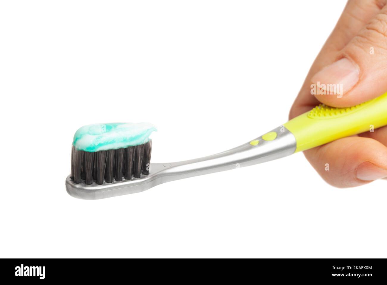 Female hand holding toothbrush with toothpaste isolated on white ...