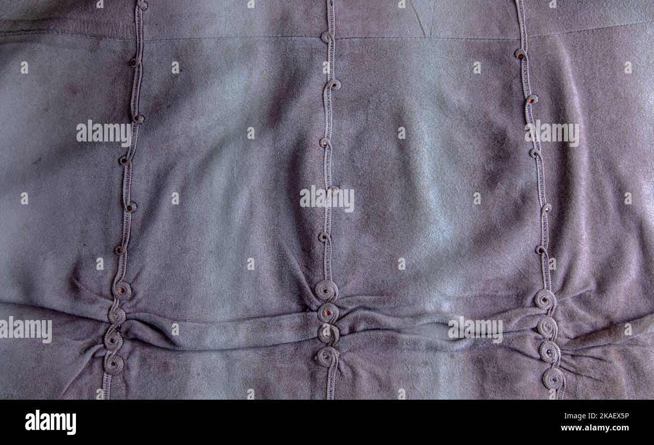 Background image of a soft beige suede product with rhinestones and ...