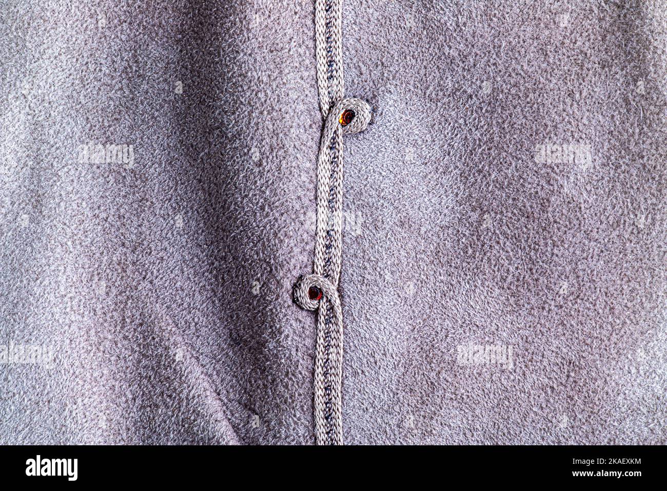 Background image of a soft beige suede product with rhinestones and ...