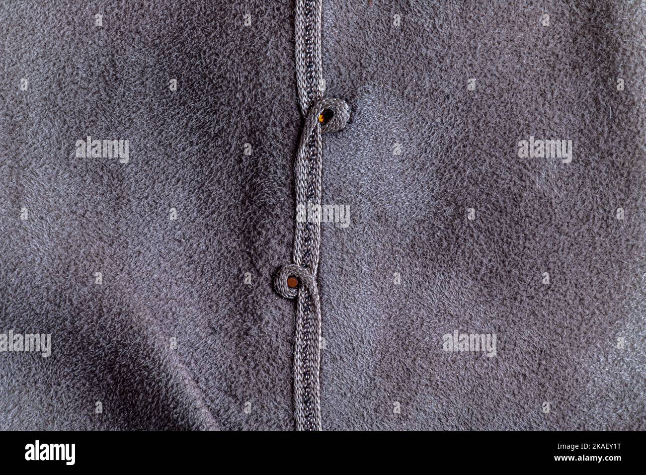 Background image of a soft beige suede product with rhinestones and ...