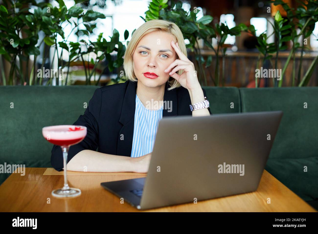 Picture of inspired attractive model writing at her laptop, spending ...
