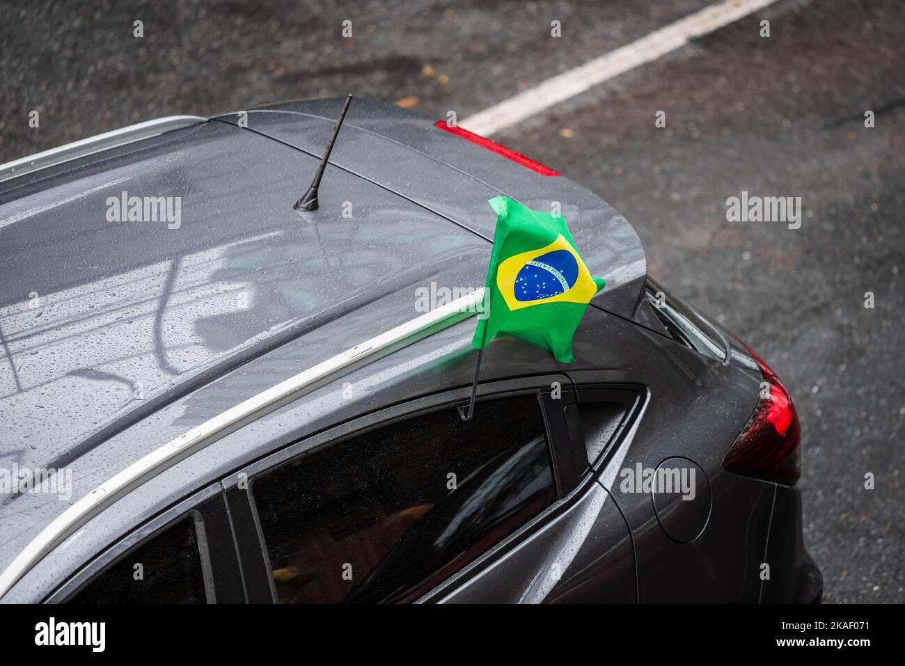 Whet grey car with Brazilian flag on the window in Belo Horizonte ...