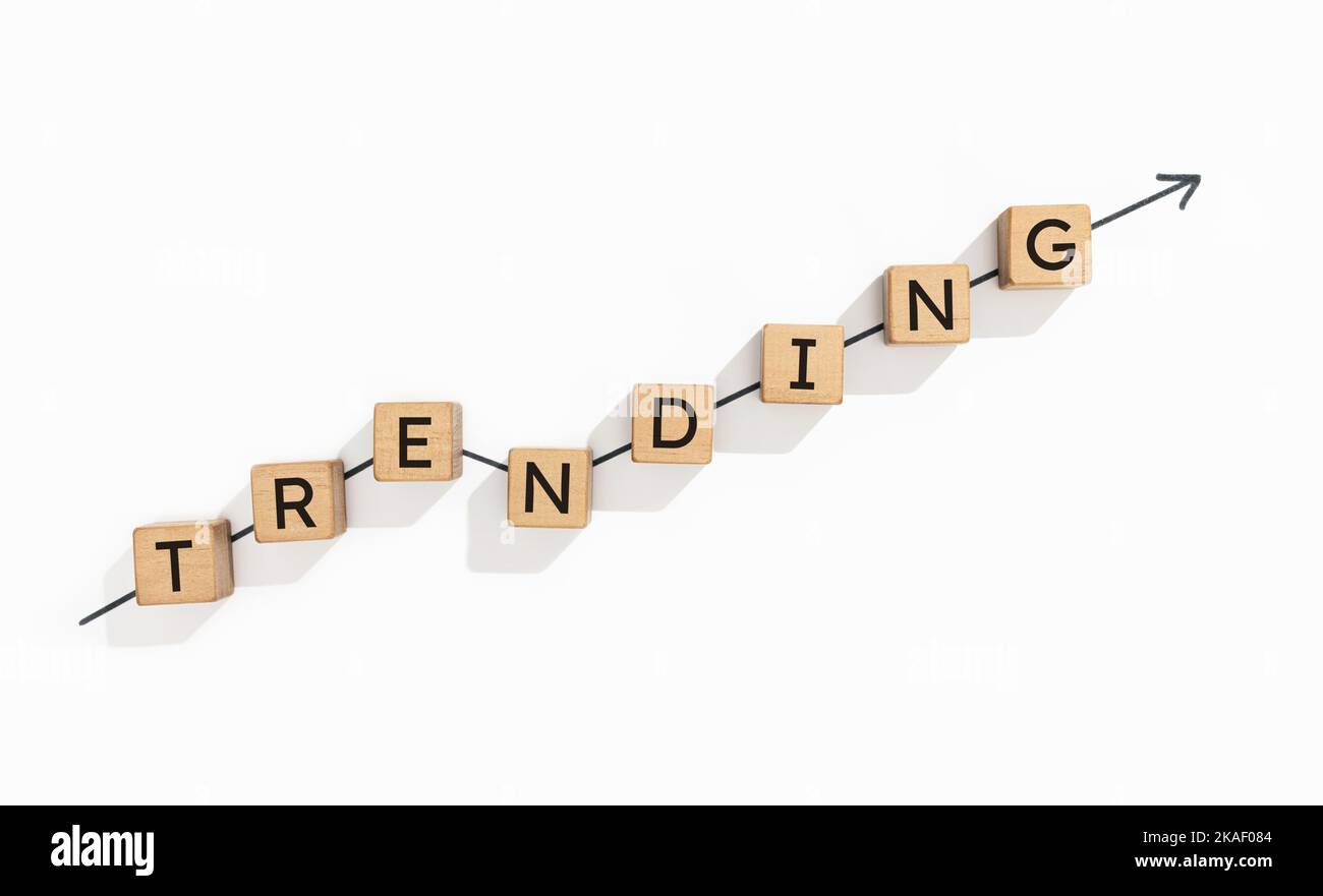 Trending word on wooden blocks on growing chart. Copy space Stock Photo ...