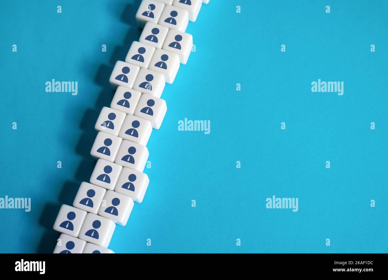 A chain of blocks of workers on a blue background. Place for text ...