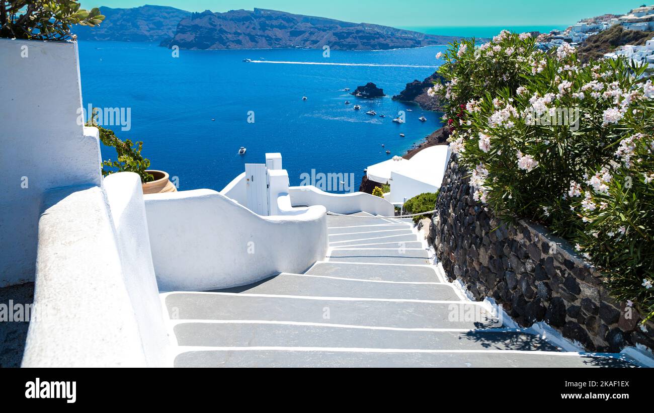 A beautiful white stone stairway leading to the shoreline in Santorini ...
