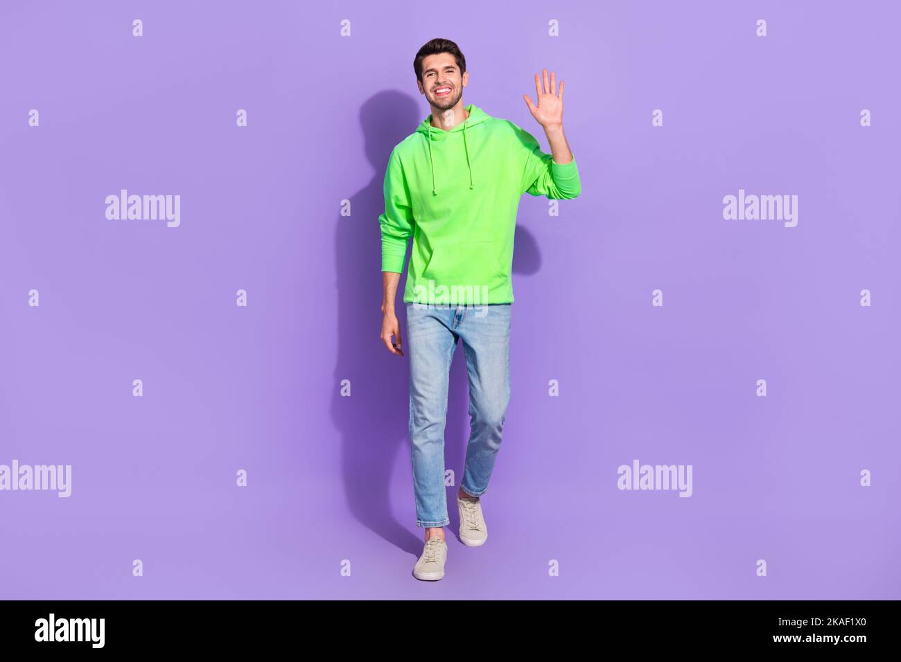 Full length photo of funny cheerful man wear green hoodie walking ...