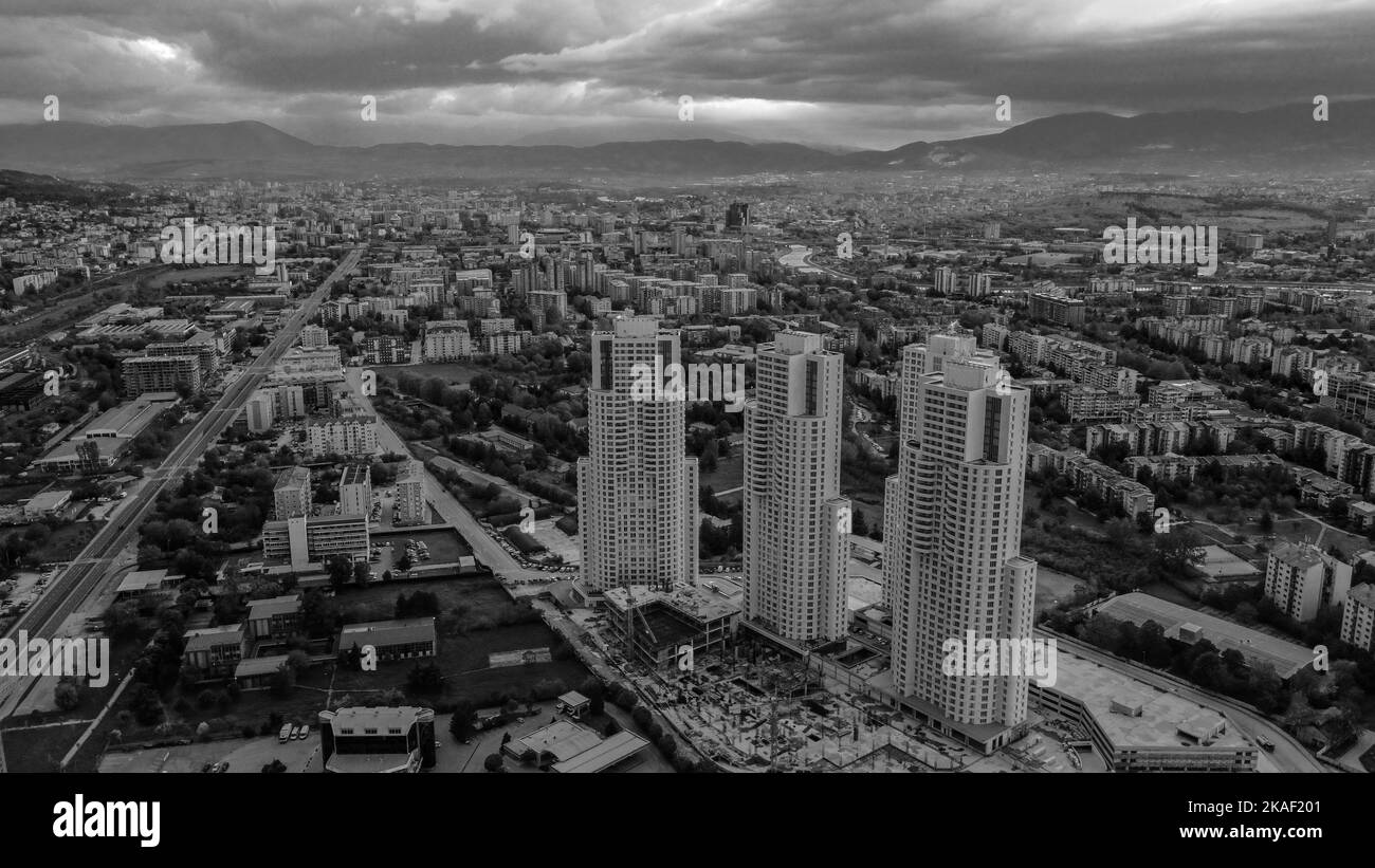 An aerial grayscale view of Skopje cityscape during cloudy sunset in ...