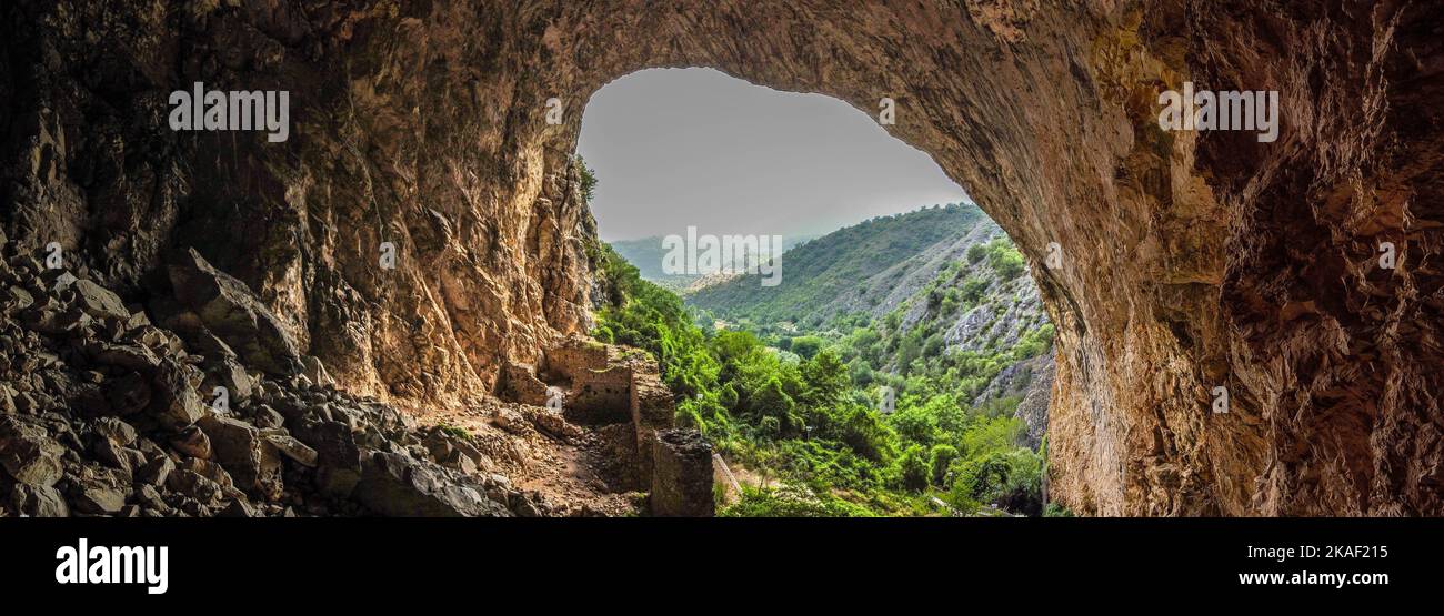 The lush green vegetation of a mountain seen through the opening of ...