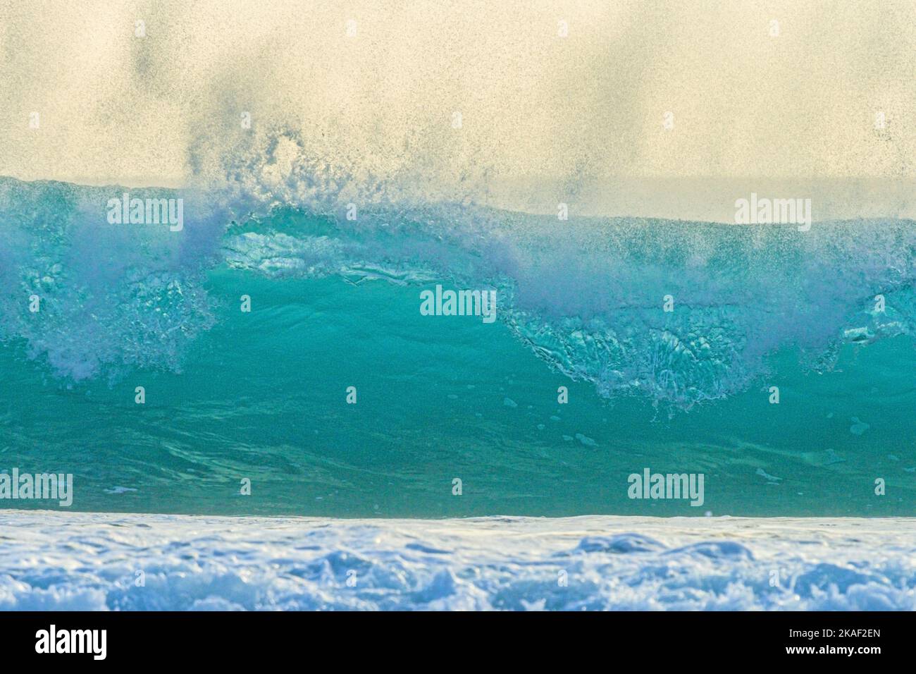 Image of wave breaking on the beach with flying spray and turquoise ...