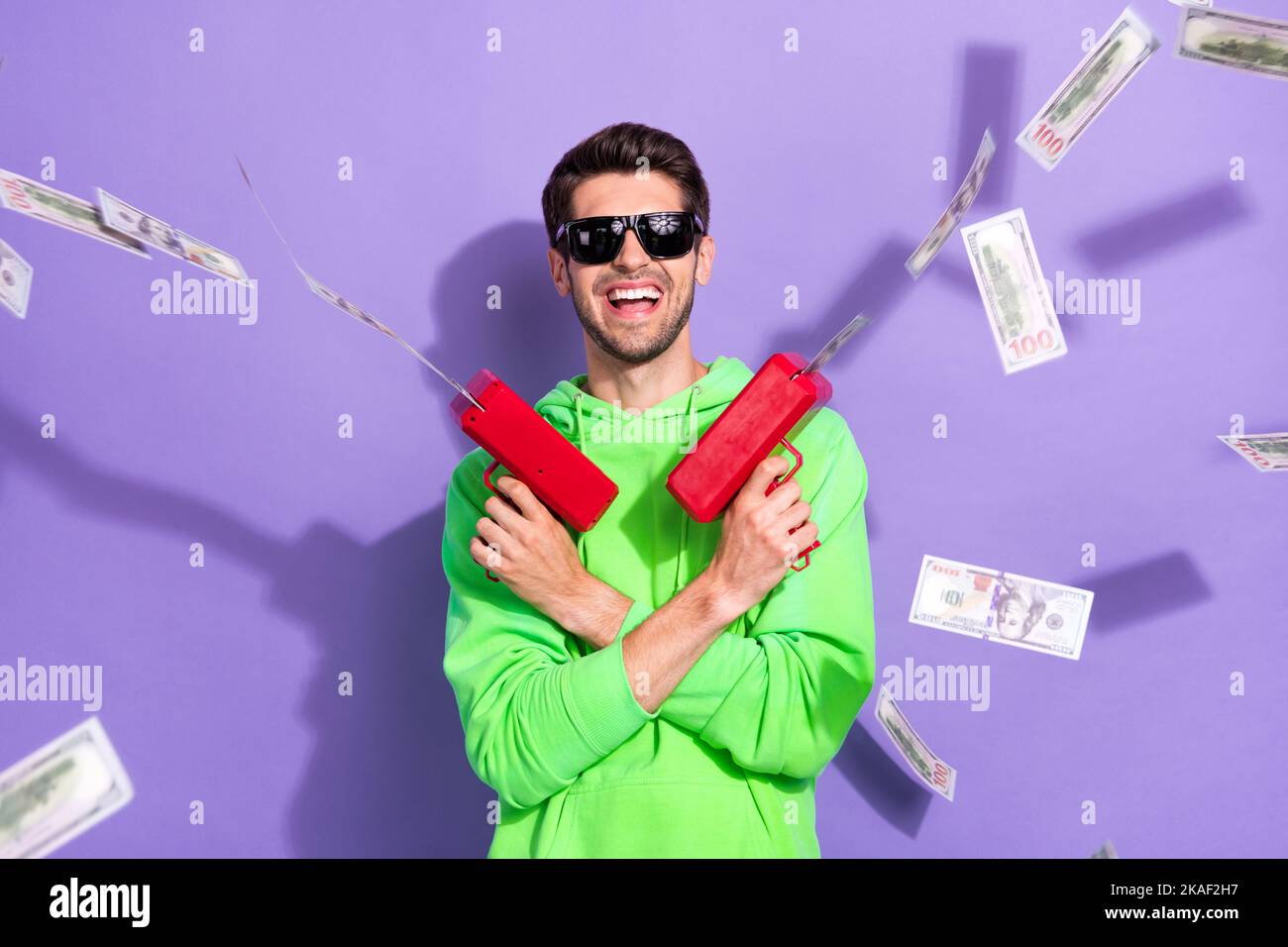 Green money gun shooting banknotes hi-res stock photography and images ...